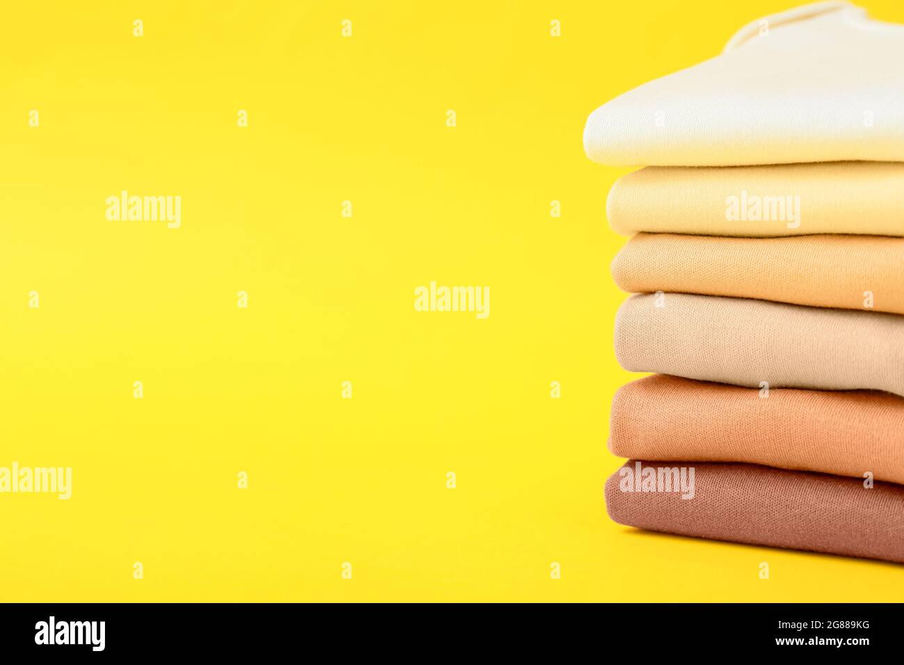 Stack of baby clothes on color background, closeup Stock Photo - Alamy