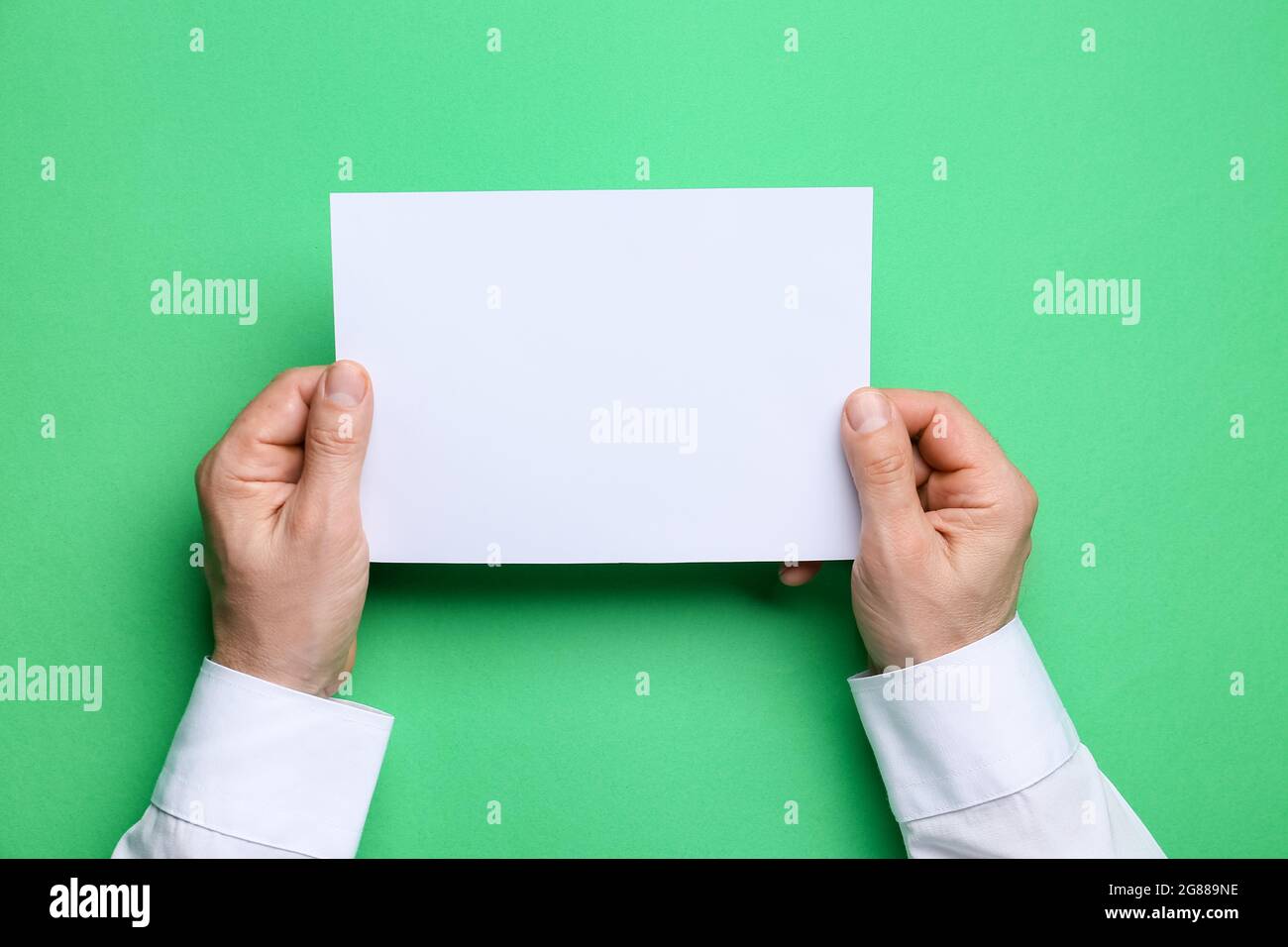 Man holding blank sheet of paper on color background, closeup Stock ...