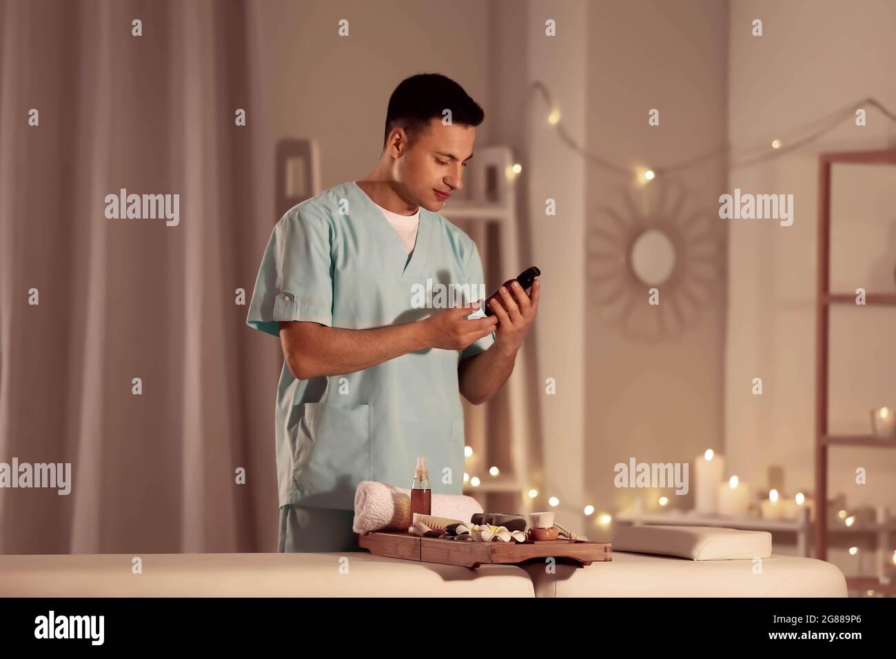 Male massage therapist in spa salon Stock Photo - Alamy