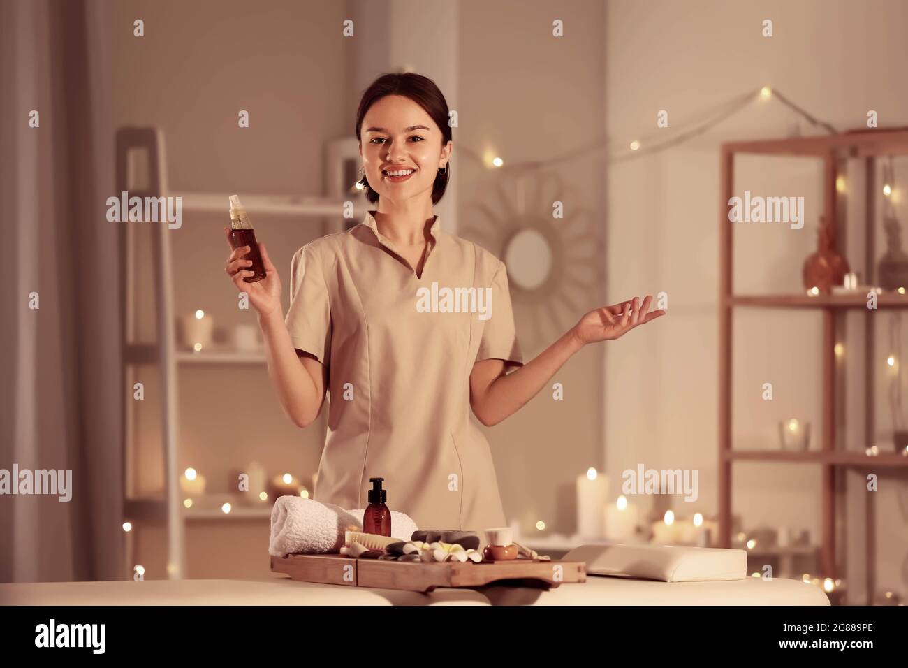 Female massage therapist in spa salon Stock Photo - Alamy