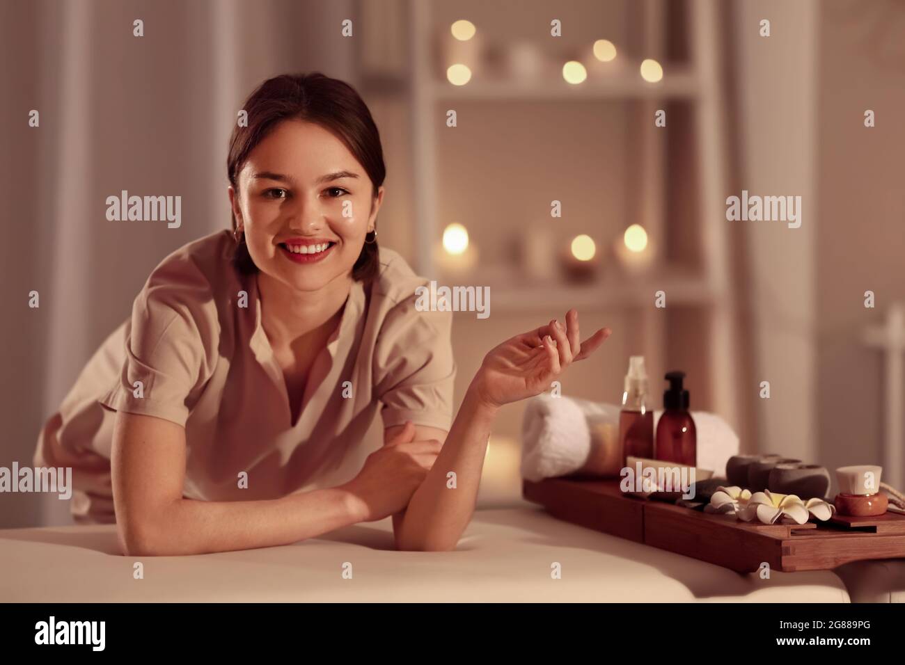 Female massage therapist in spa salon Stock Photo - Alamy