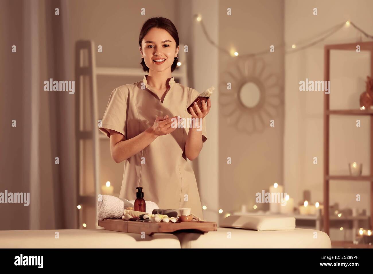 Female massage therapist in spa salon Stock Photo - Alamy