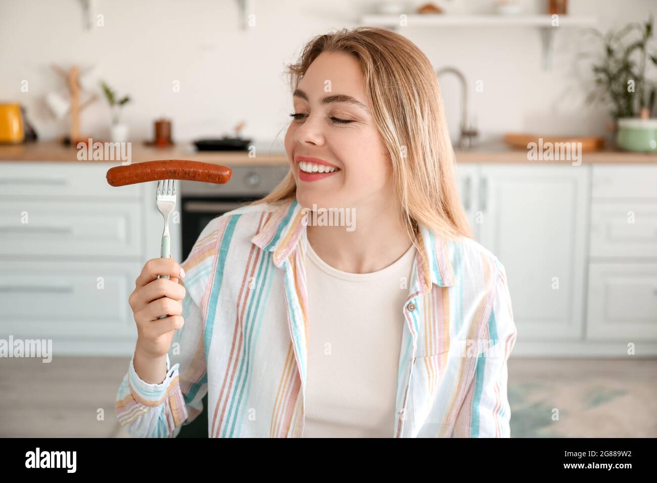 Woman eating pork sausage hi-res stock photography and images - Alamy