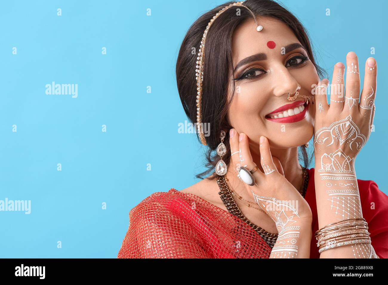 Beautiful Indian woman on color background Stock Photo - Alamy