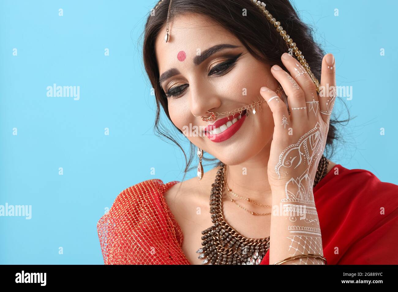 Beautiful Indian woman on color background Stock Photo - Alamy