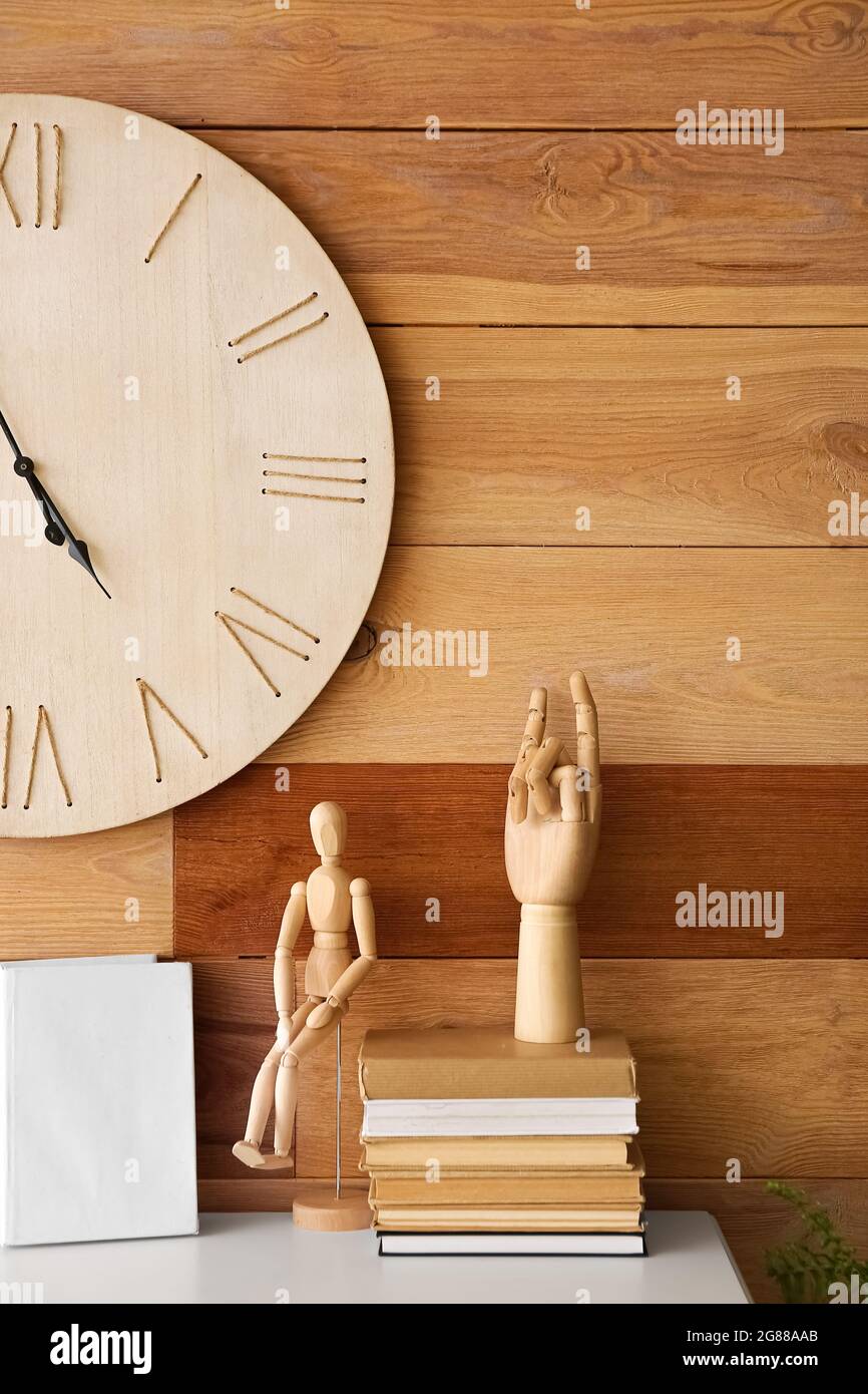 Table with decor near wooden wall Stock Photo - Alamy