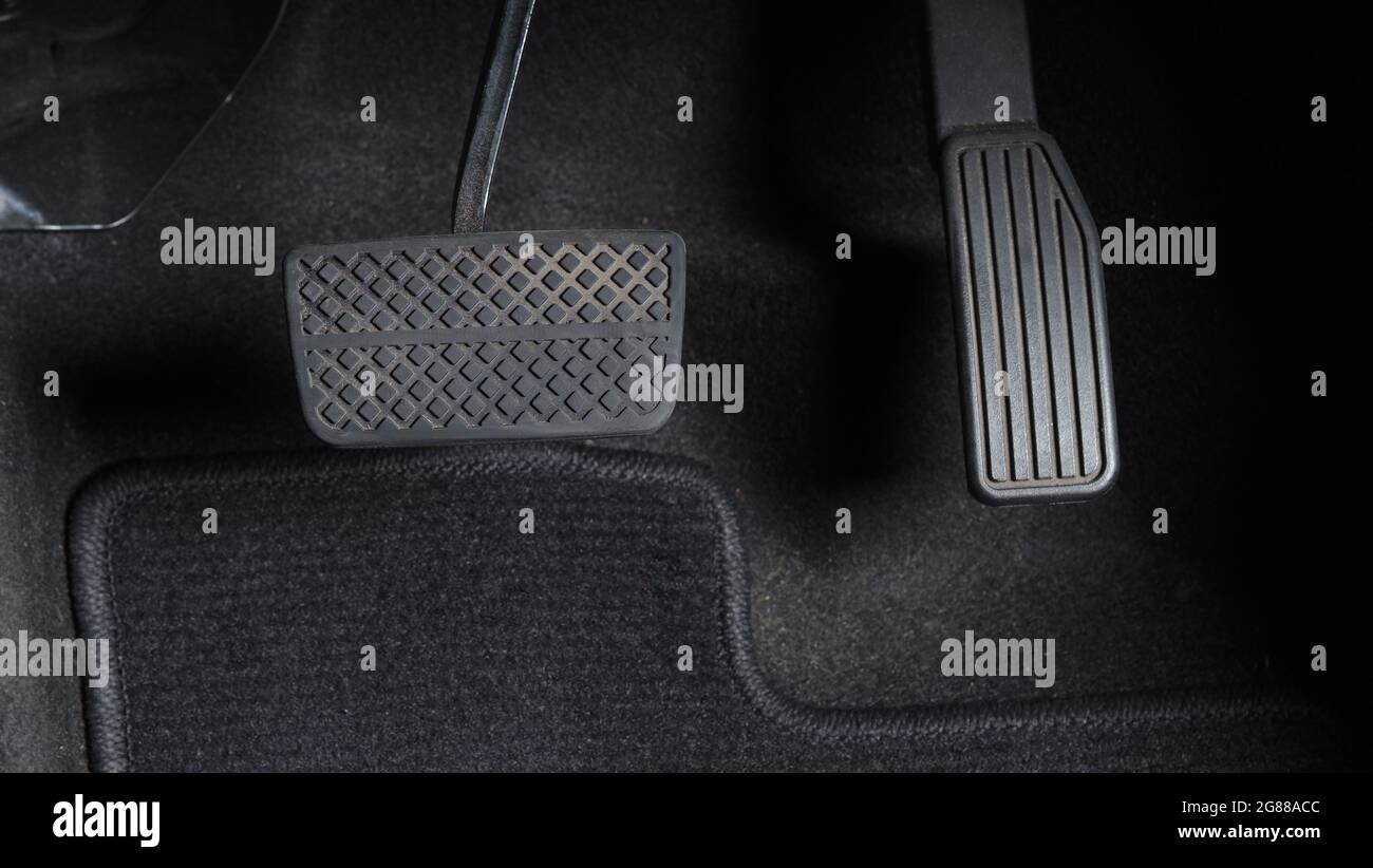 Man foot and accelerator and brake pedal inside the car or vehicle and ...