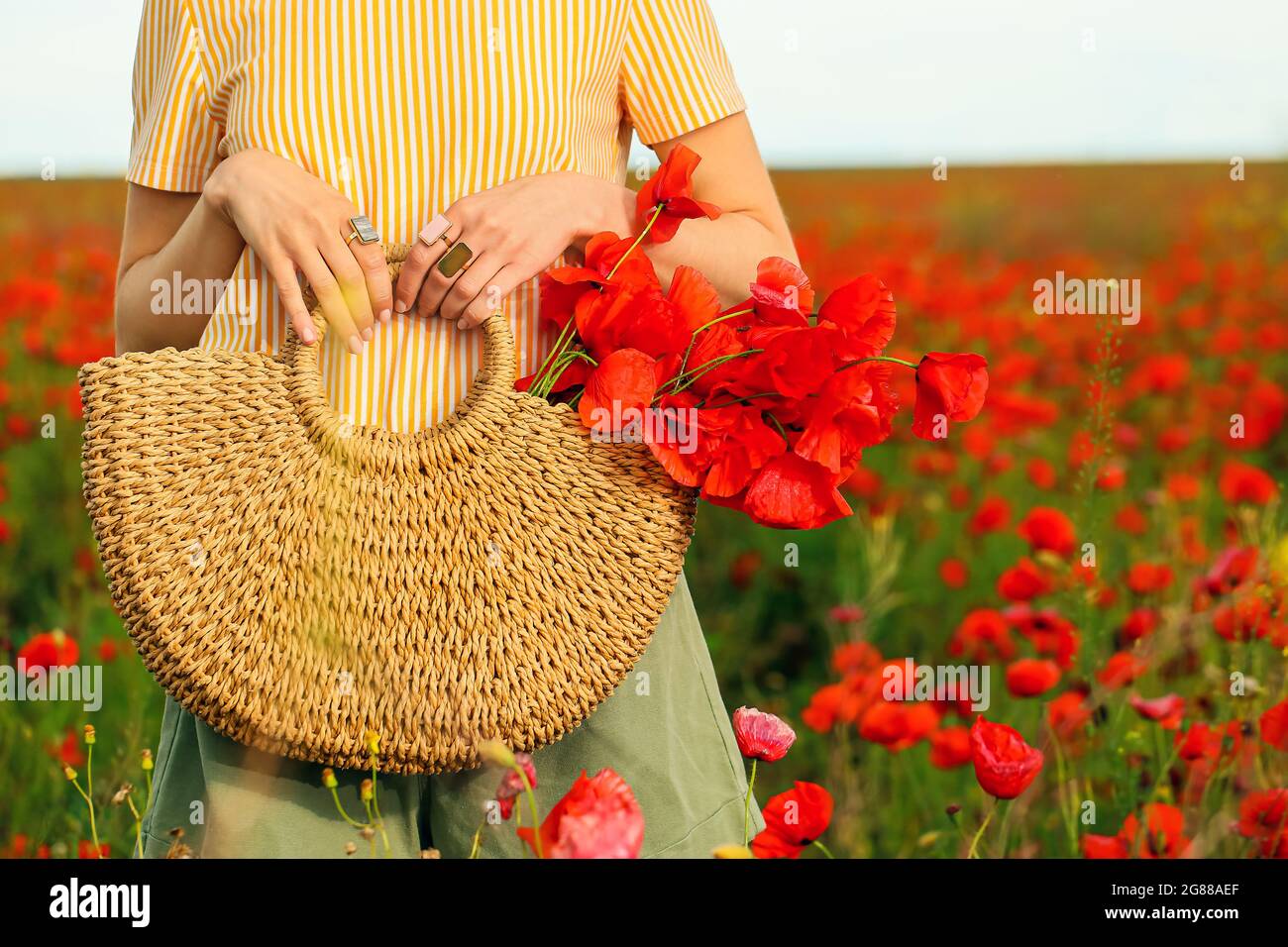 Beautiful young woman in poppy field Stock Photo - Alamy