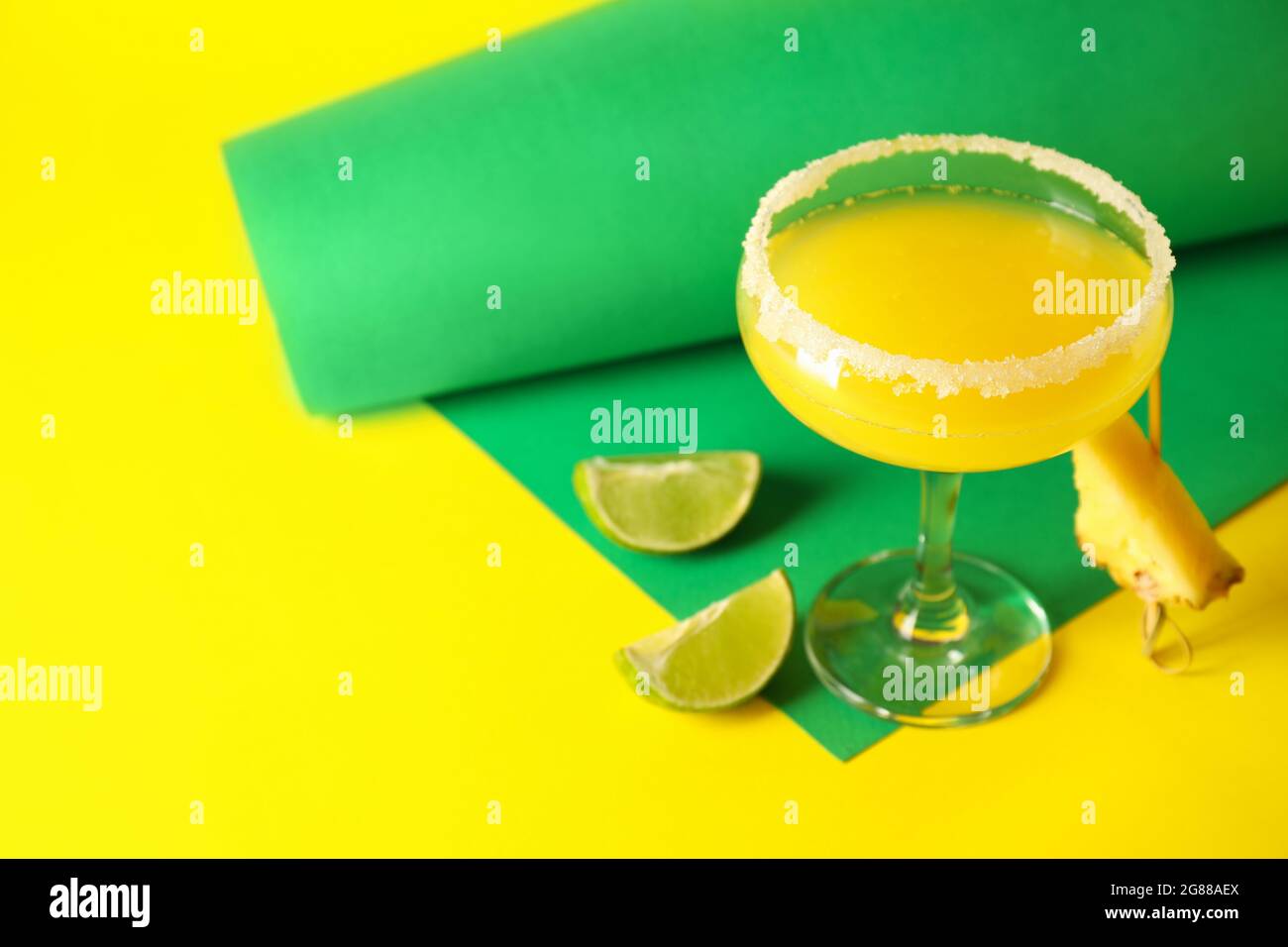 Glass of pineapple daiquiri cocktail on color background Stock Photo ...