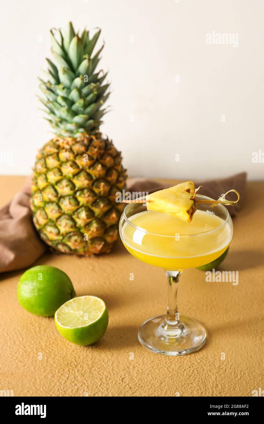 Glass of pineapple daiquiri cocktail on light background Stock Photo ...