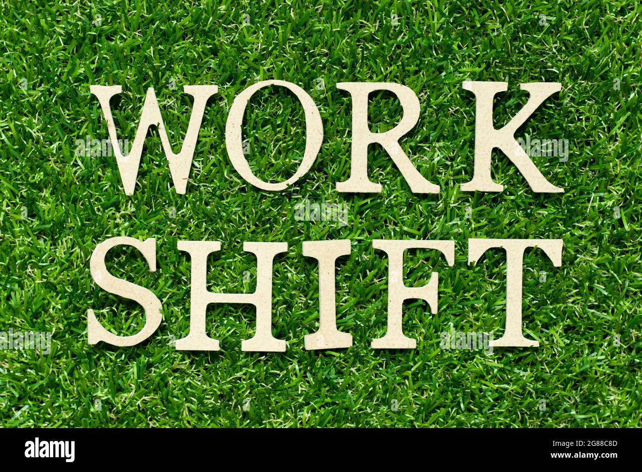 Wood letter in word work shift on green grass background Stock Photo ...