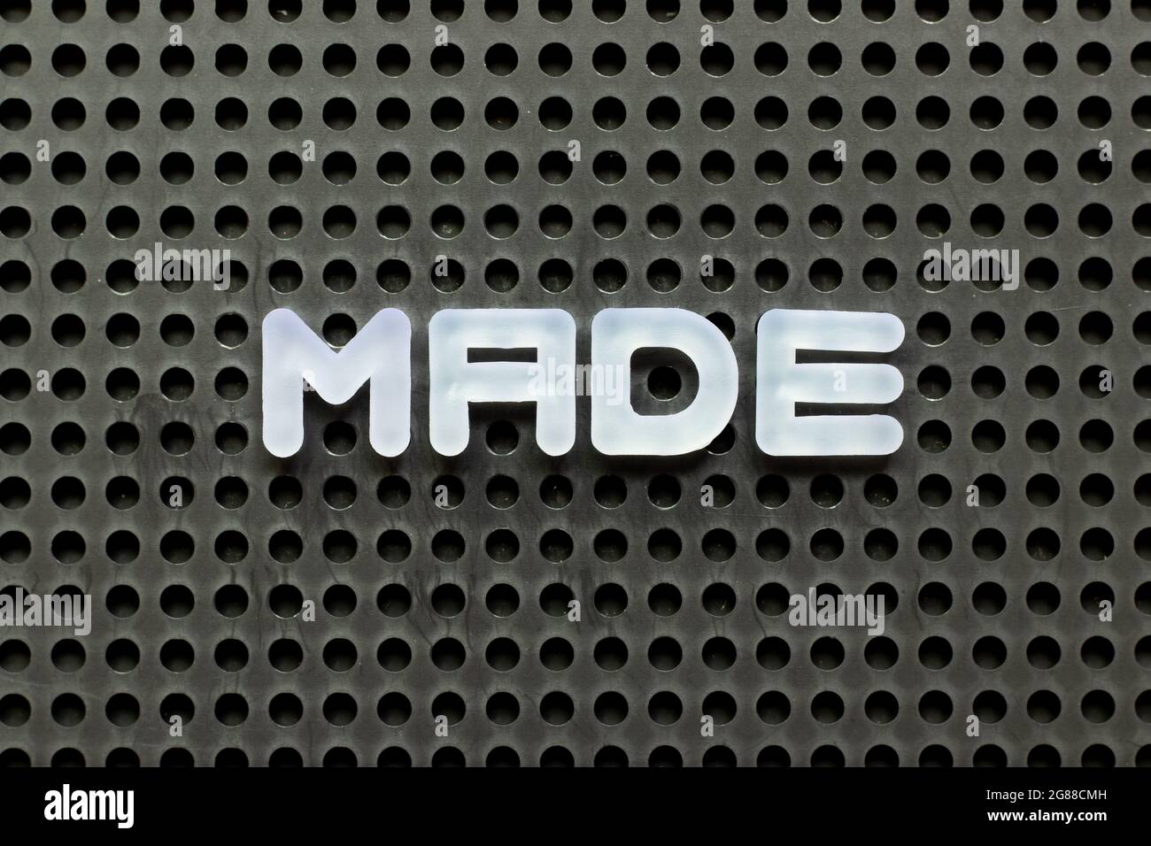 White color letter in word made on black pegboard background Stock ...