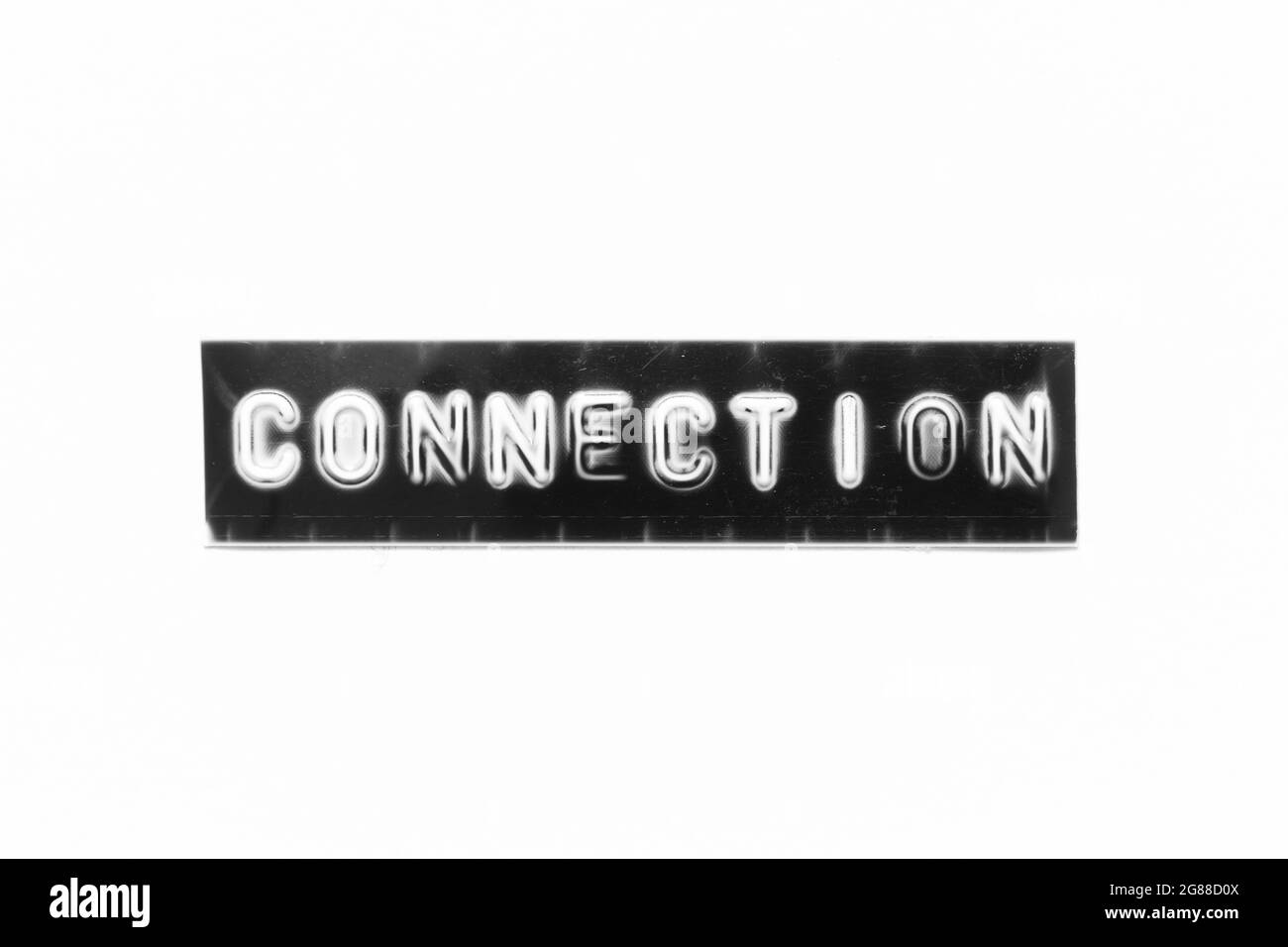 Embossed letter with word connection in black banner on white paper ...