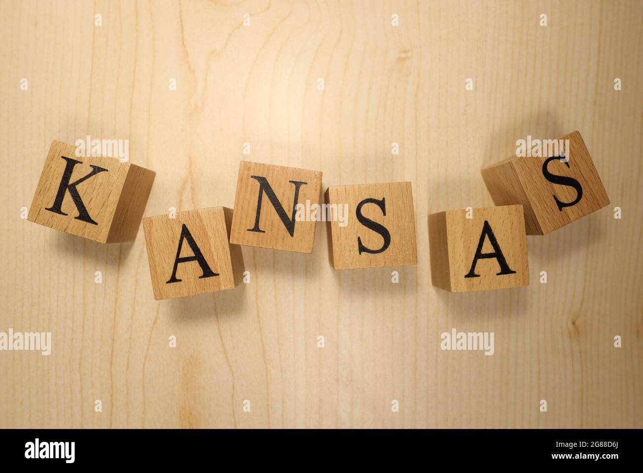 The word Kansas was created from wooden letter cubes. Cities and words ...