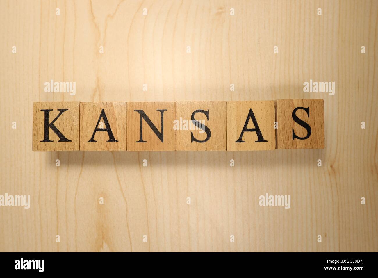The word Kansas was created from wooden letter cubes. Cities and words ...