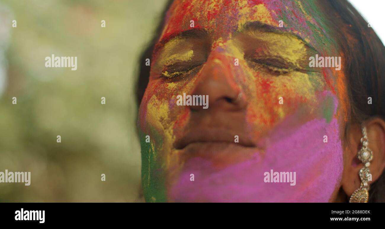 A colored face of an Indian female attending the Holi festival ...