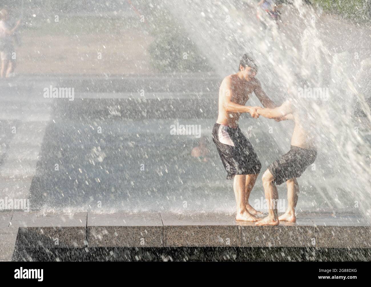 Two boys playing in water hi-res stock photography and images - Alamy