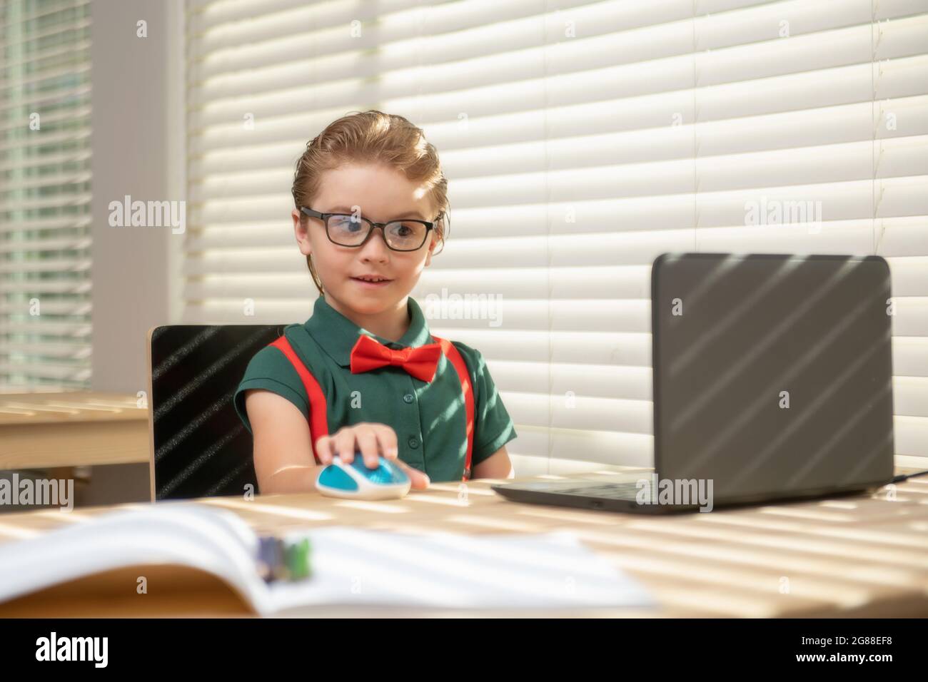 Online remote learning. School kids with computer having video ...
