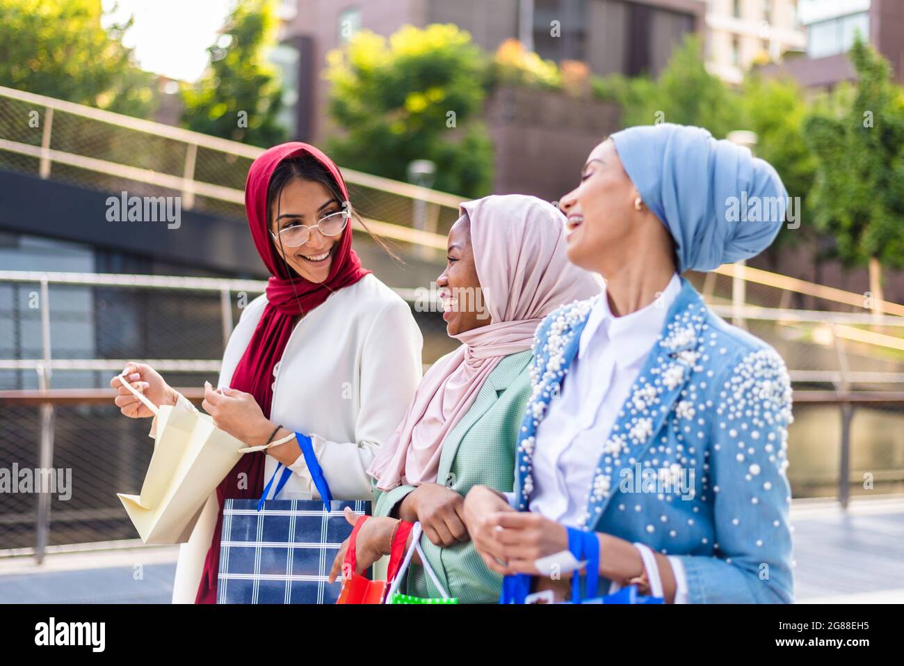 Multiethnic group of muslim girls wearing casual clothes and ...