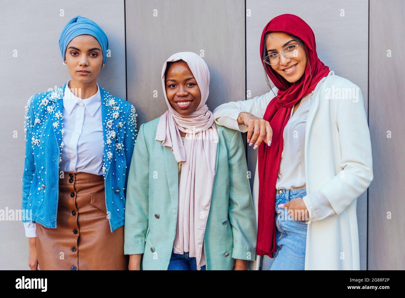 Multiethnic group of muslim girls wearing casual clothes and ...
