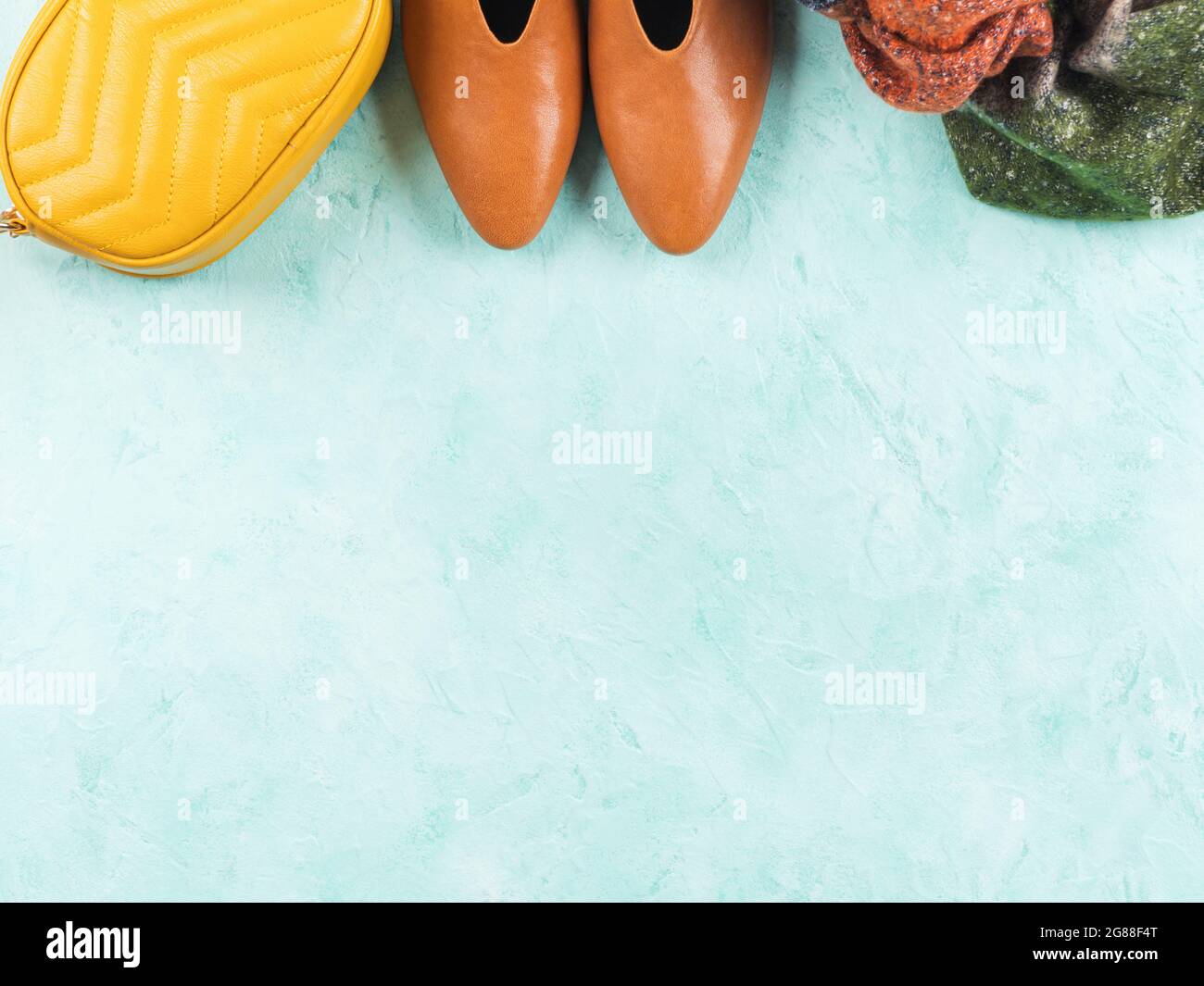 Fall pump shoes with autumn scarf and yellow handbag on turquoise ...