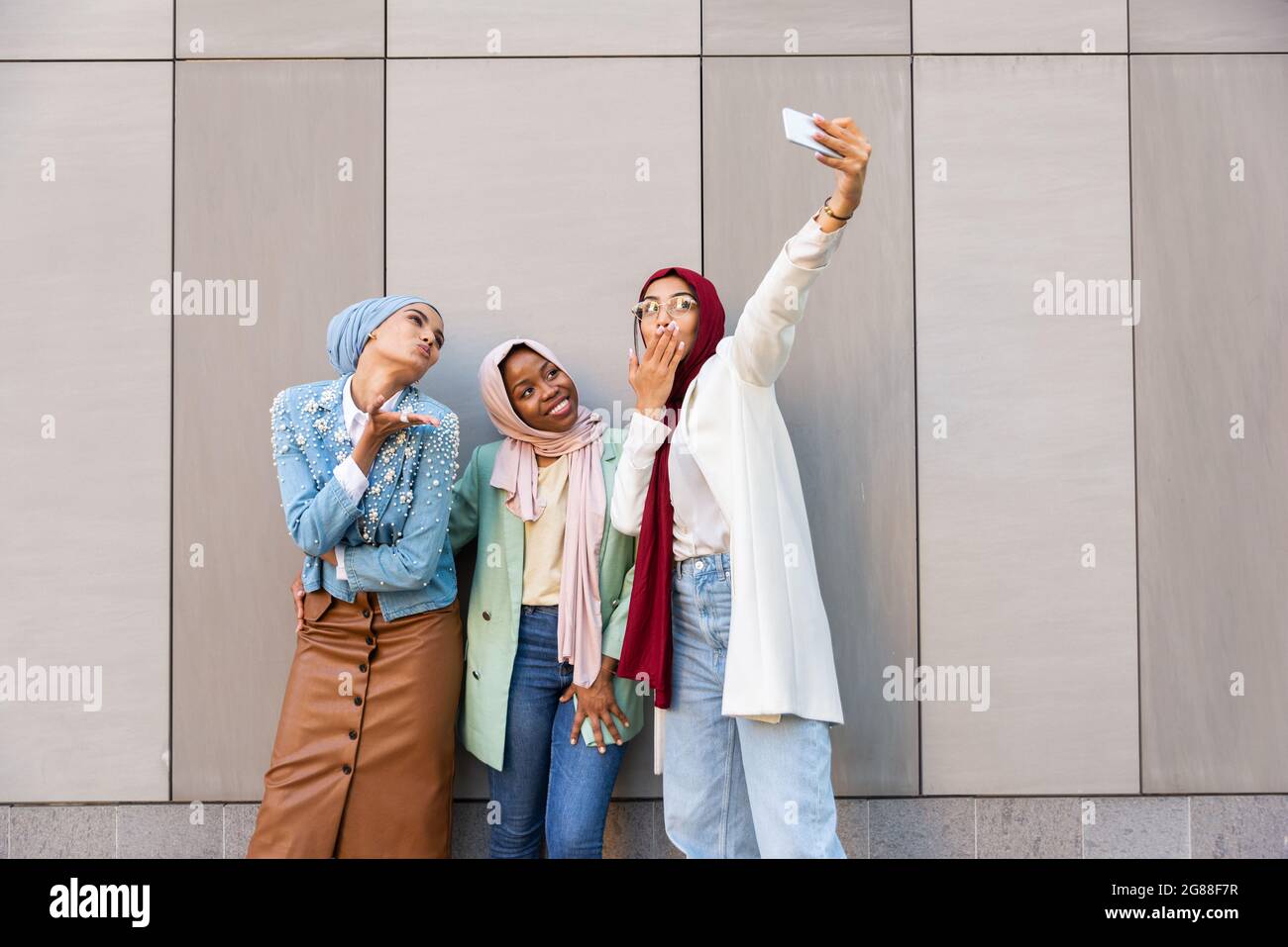 Multiethnic group of muslim girls wearing casual clothes and ...