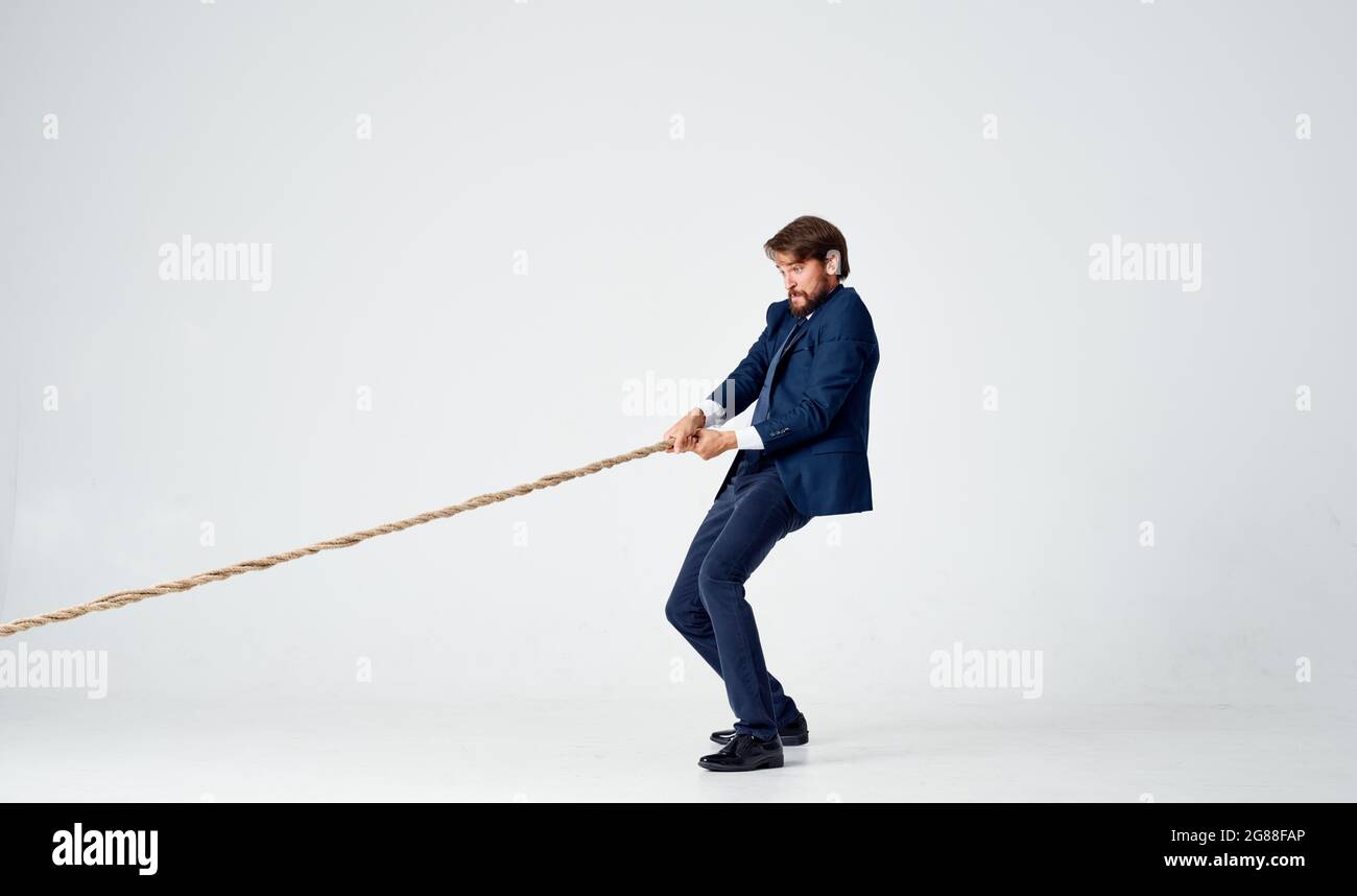 business man in suit pulling rope career office manager Stock Photo - Alamy