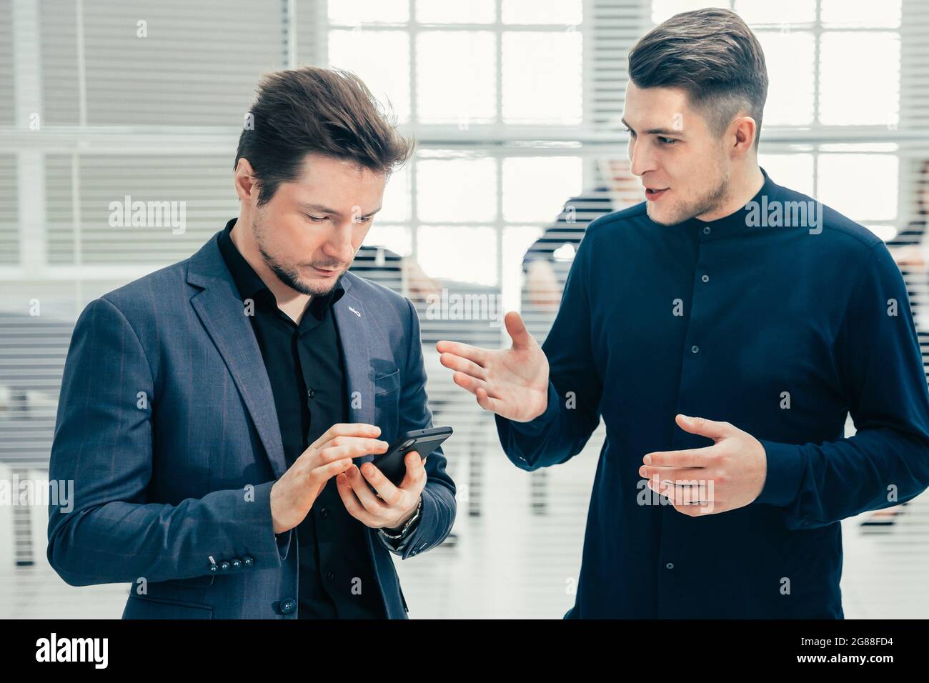 group of employees talking standing in the office Stock Photo - Alamy