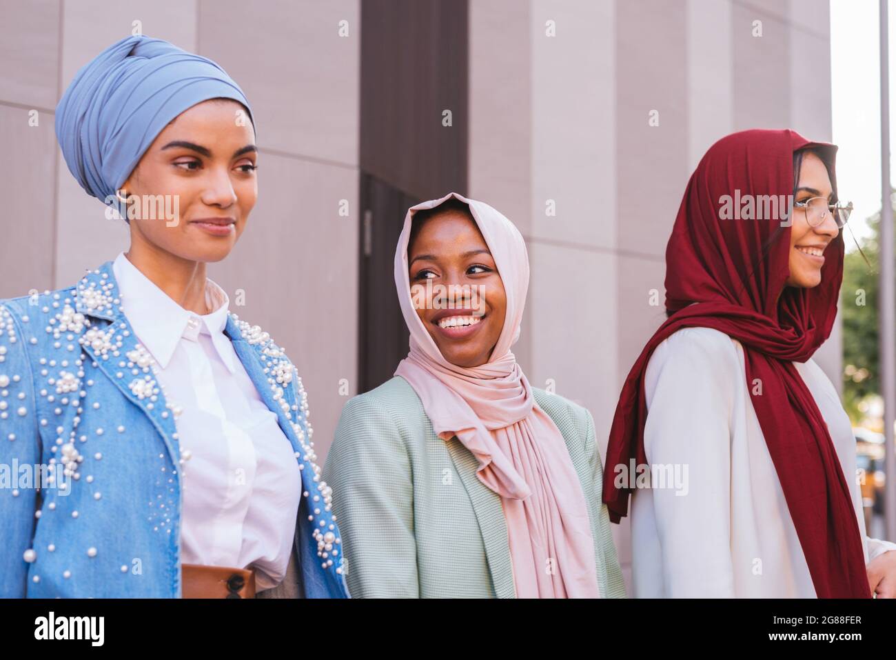 Multiethnic group of muslim girls wearing casual clothes and ...