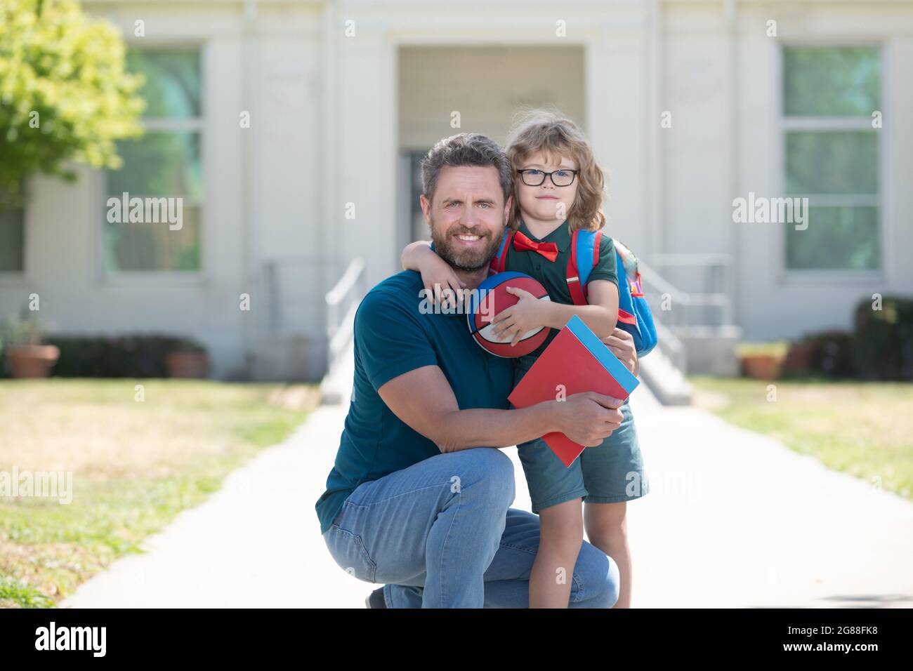 father and son come back from school. happy family values. childhood ...