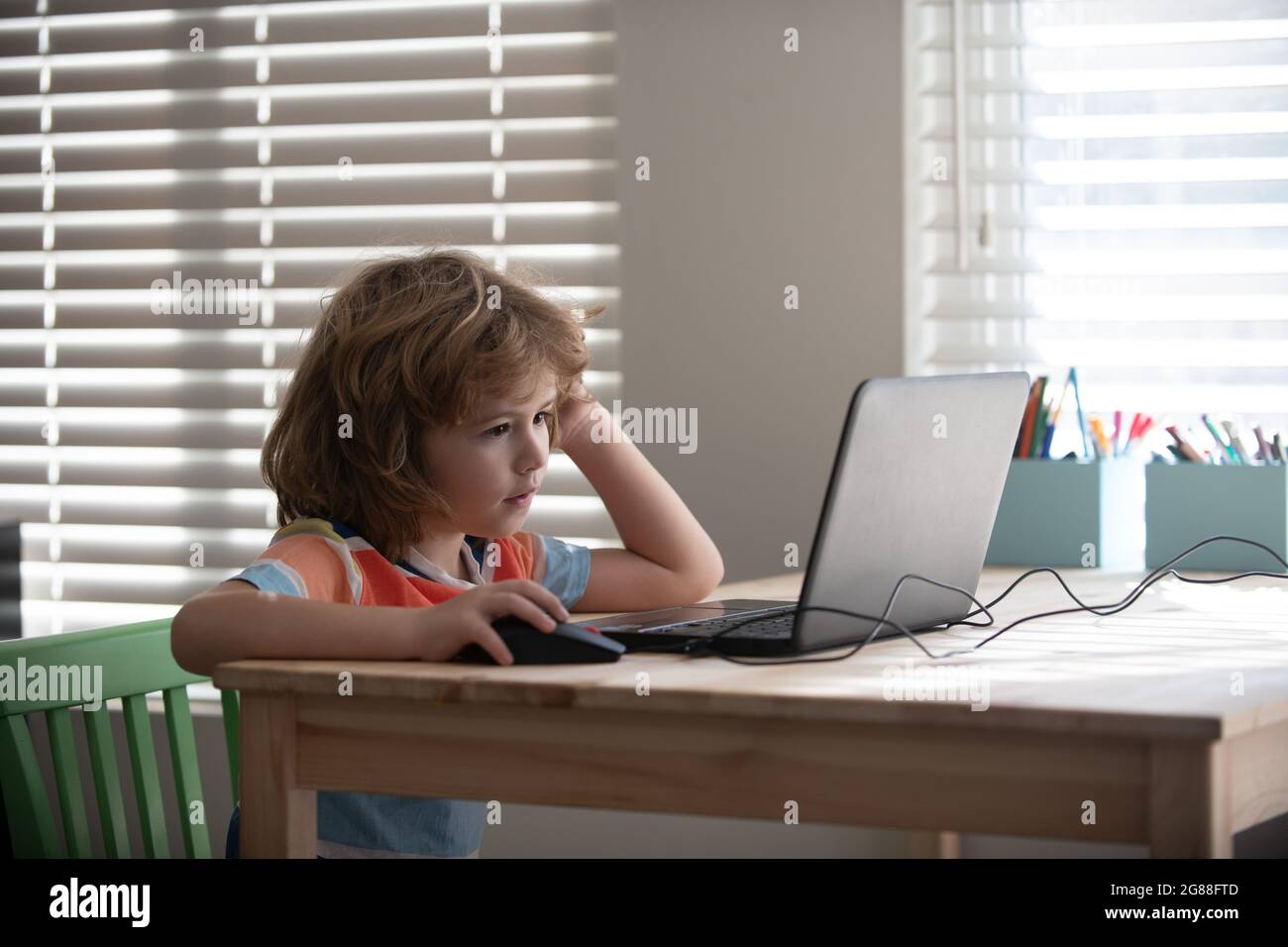 School boy using a laptop computer at school Stock Photo - Alamy