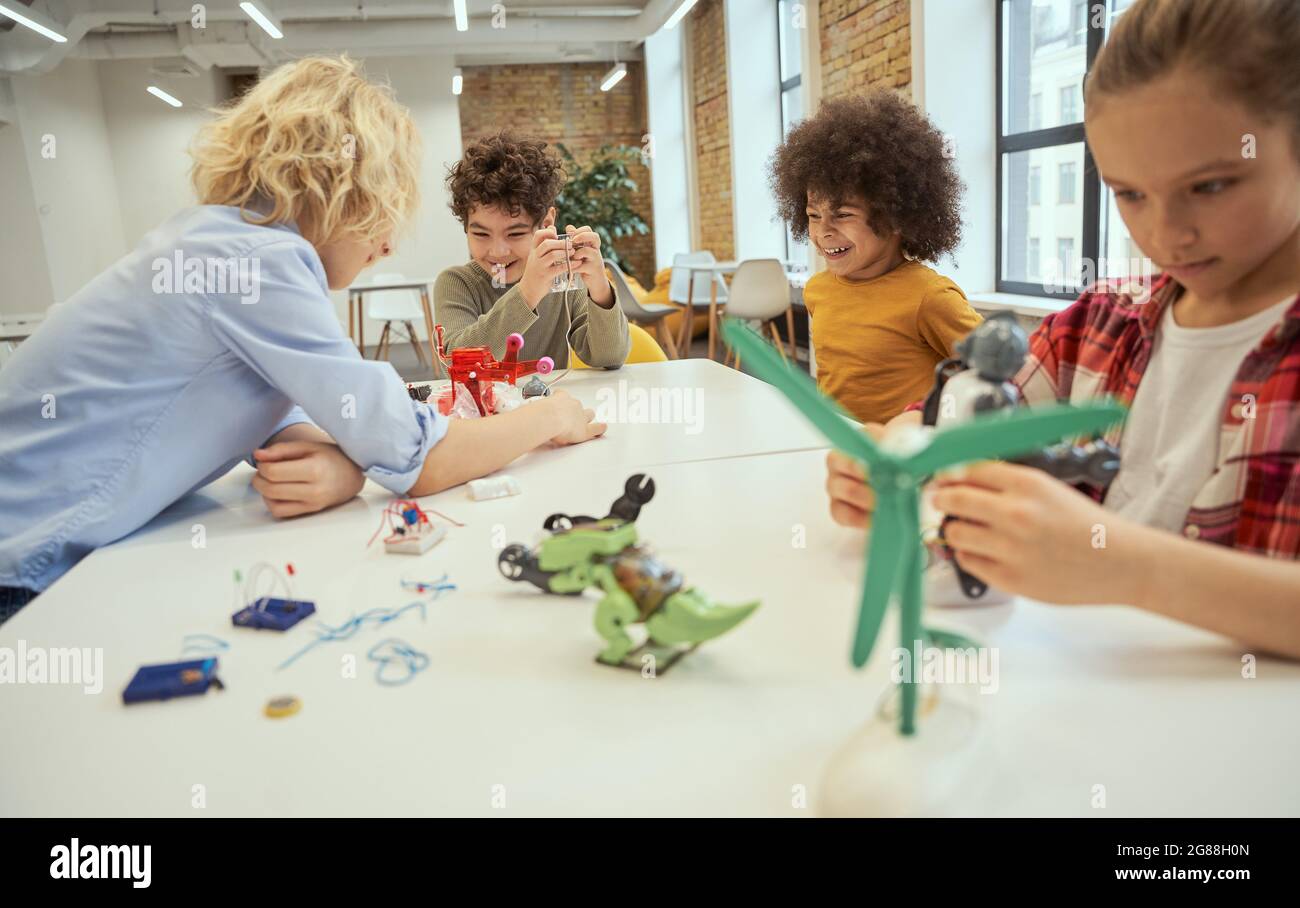 Group of school children discussing hi-res stock photography and images ...