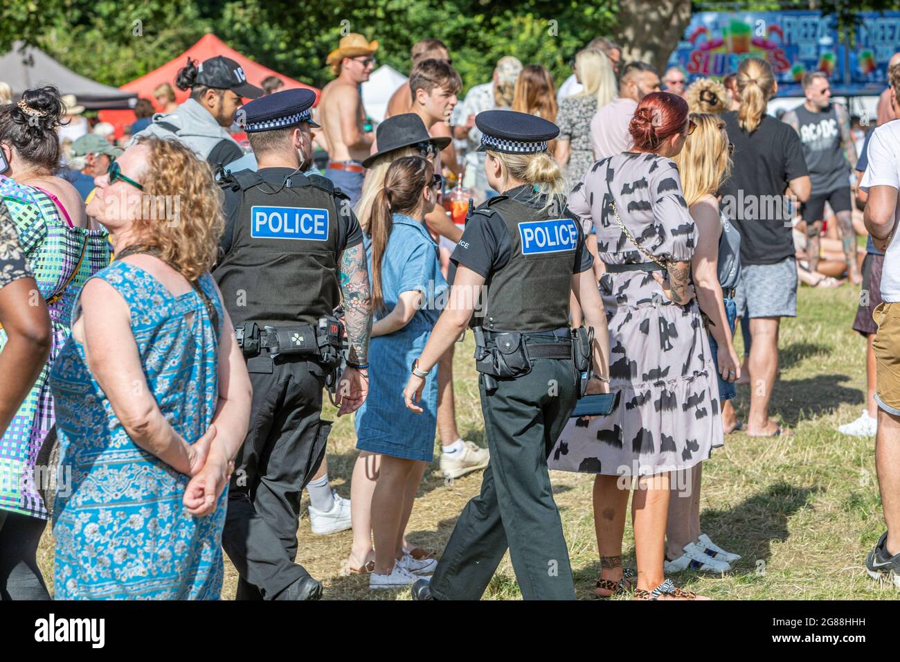 Two police officers patrolling at a crowded food and drink festival ...