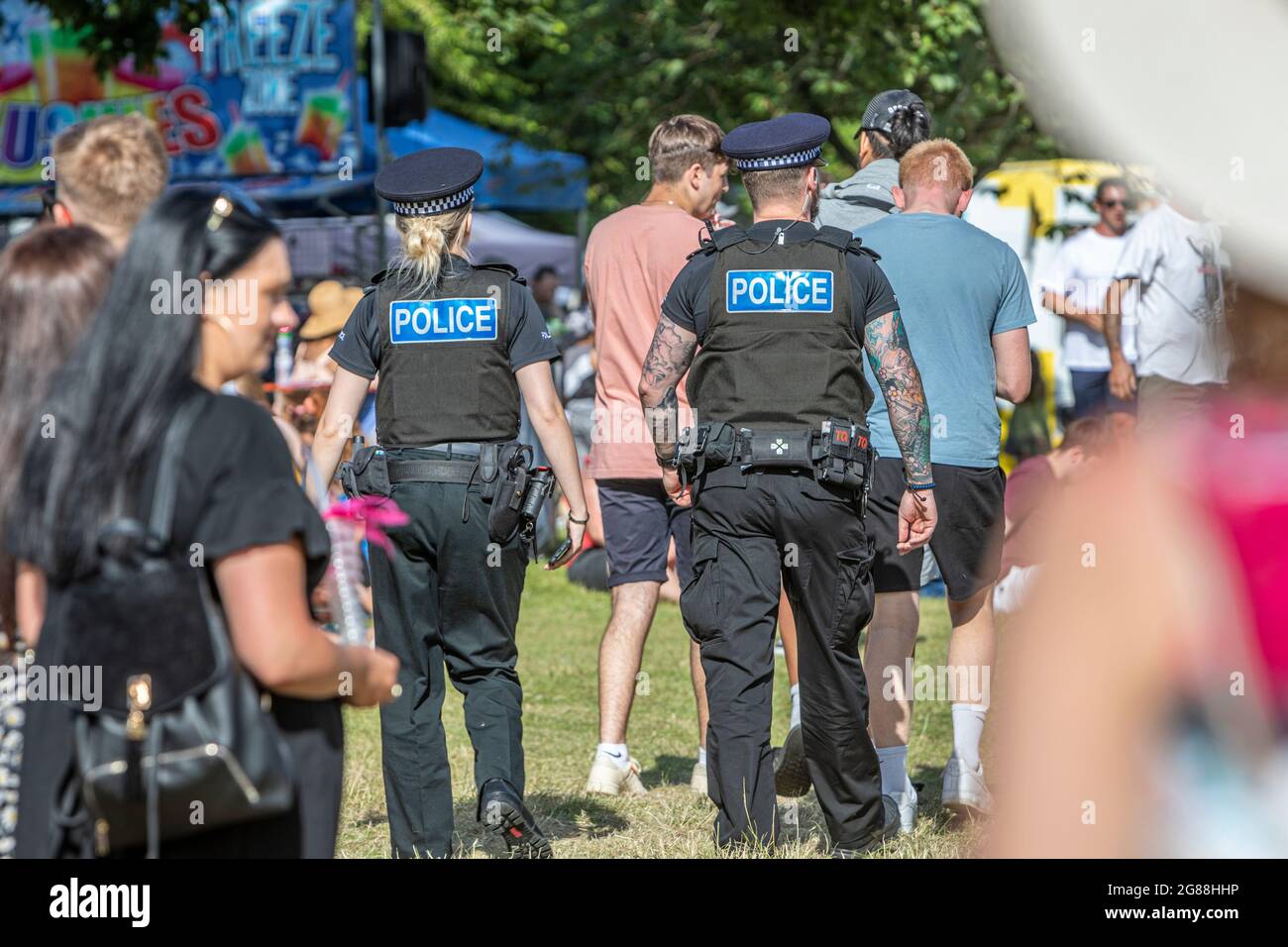 Two police officers patrolling at a crowded food and drink festival ...
