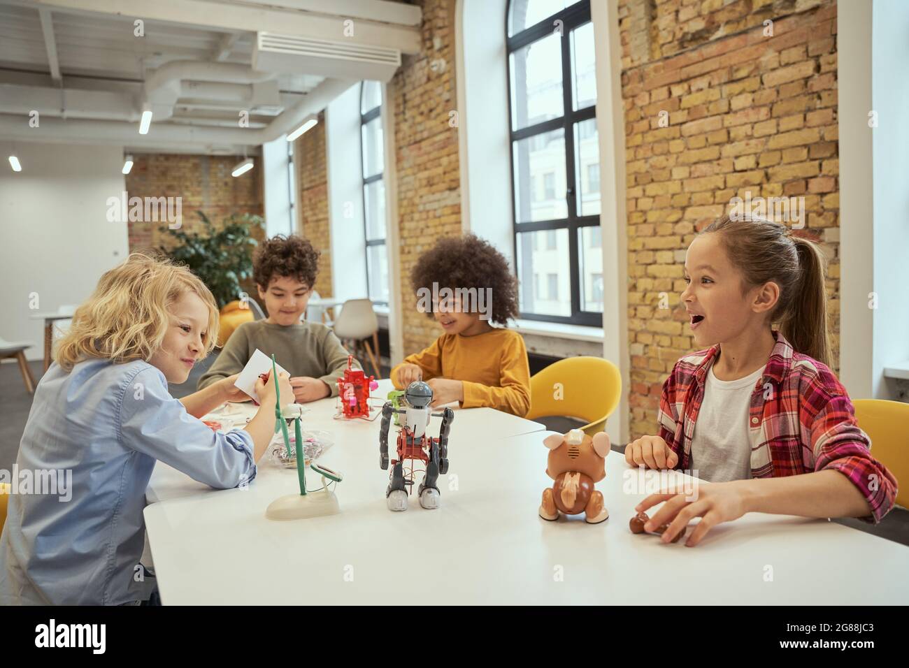 Creativity. Lively diverse kids looking excited while playing with ...