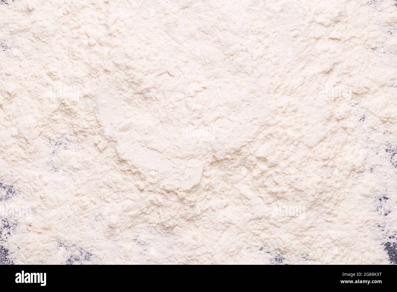 Baking or cooking background, flour on the dark background. Top view ...