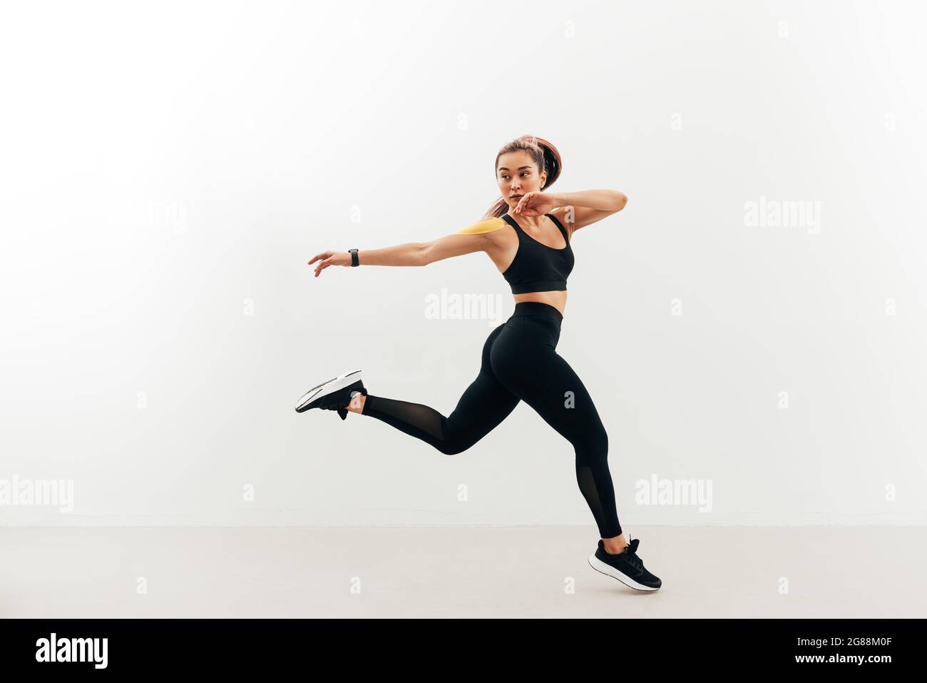 Woman running looking back hi-res stock photography and images - Alamy