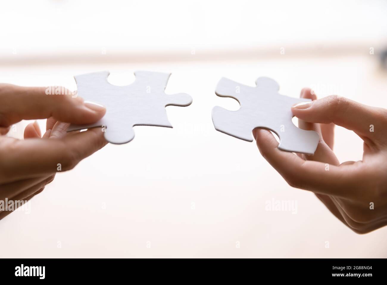 Human connecting two pieces of puzzle. Woman joining jigsaw parts Stock ...