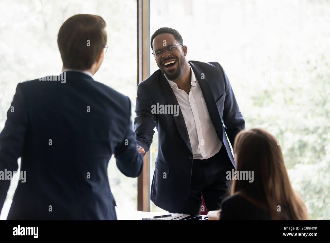 Happy diverse business leader and client shaking hands on meeting Stock ...