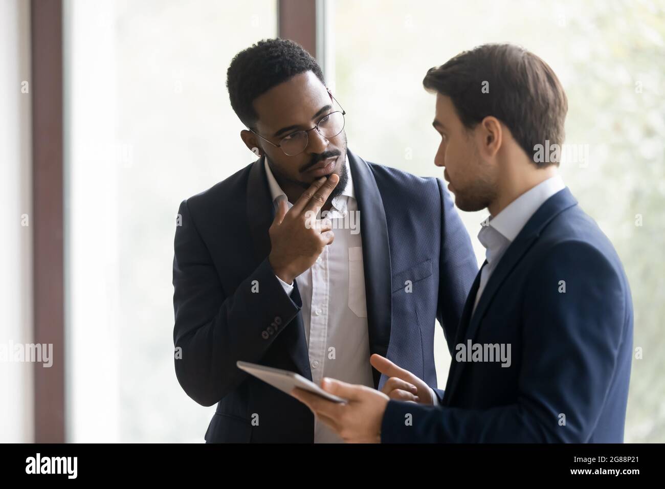 Serious business mentor, coach training Black intern Stock Photo - Alamy