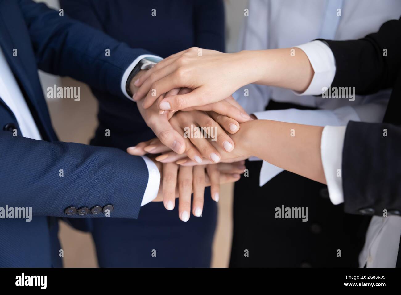 Team of office employees making community pile of hands gesture Stock ...