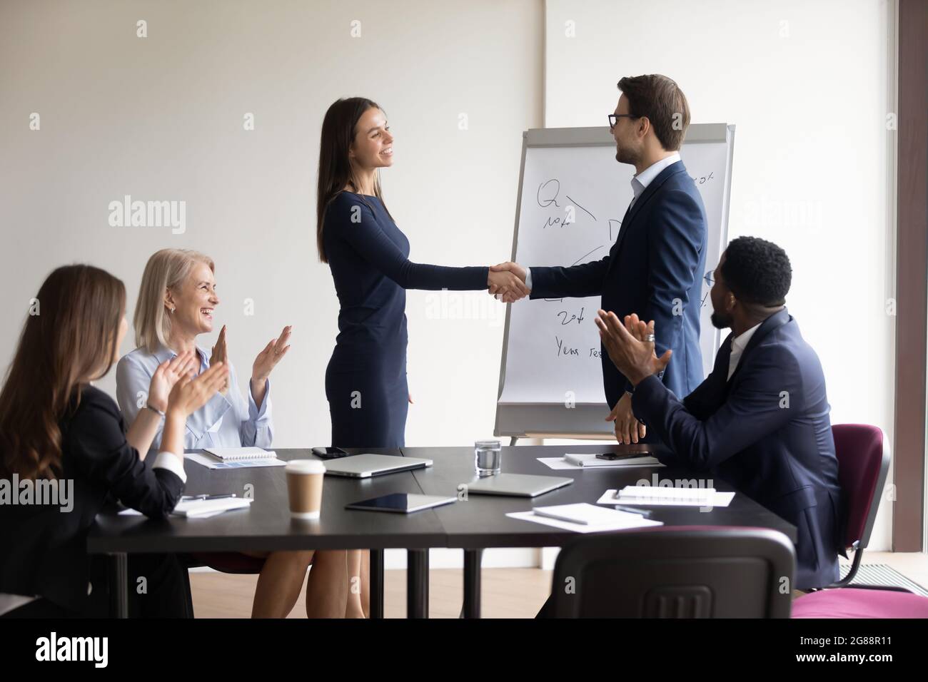 Happy excited promoted employee shaking hands with boss Stock Photo - Alamy