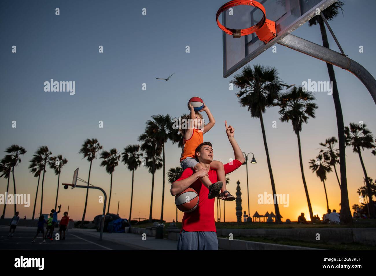 Funny team training basketball, boy with coach. Trainer holding kid boy ...