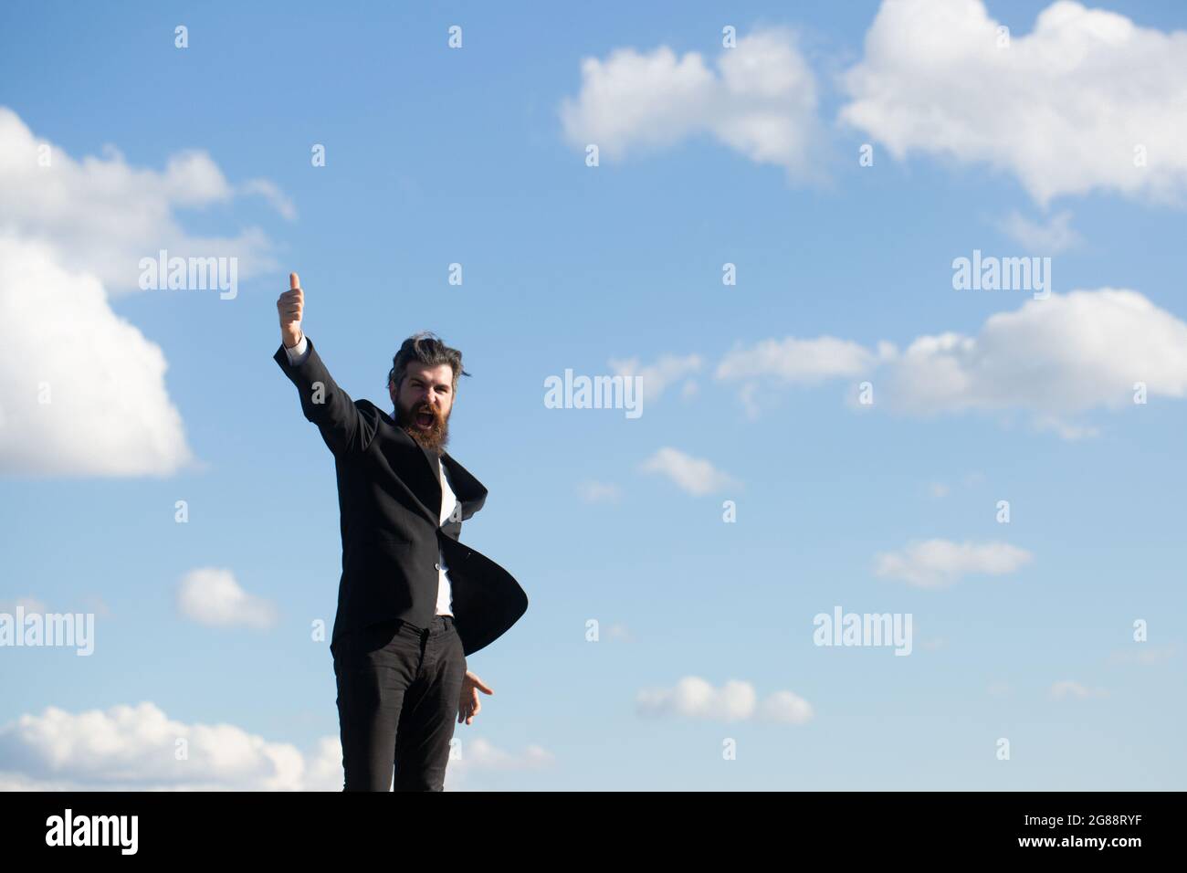 Man in suit hand raising on sky background. Freedom adventure and ...