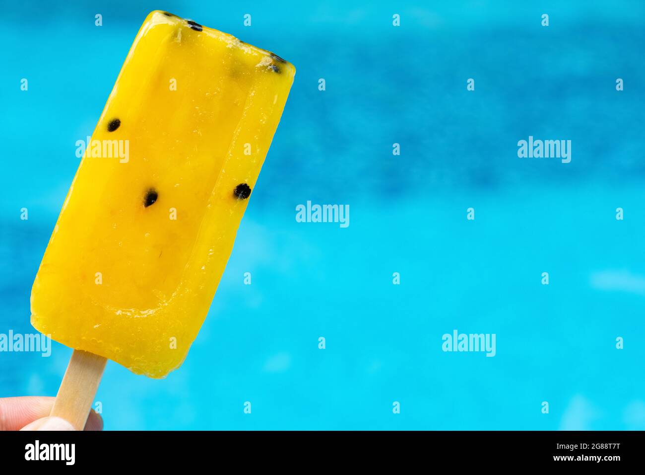 a passion fruit popsicle in front of a swimming pool Stock Photo - Alamy