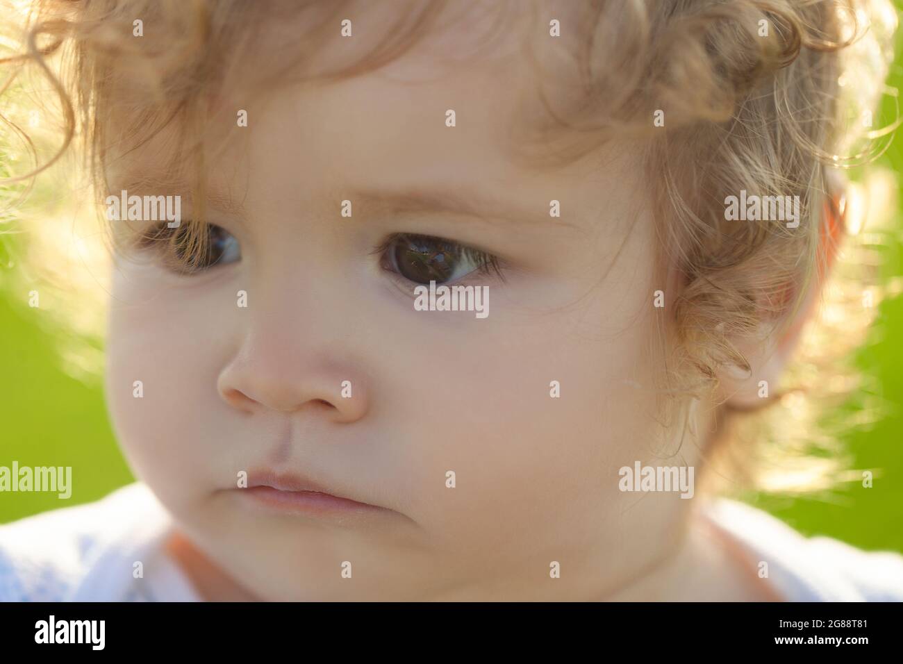 Funny child face close up. Kids baby serious portrait Stock Photo - Alamy