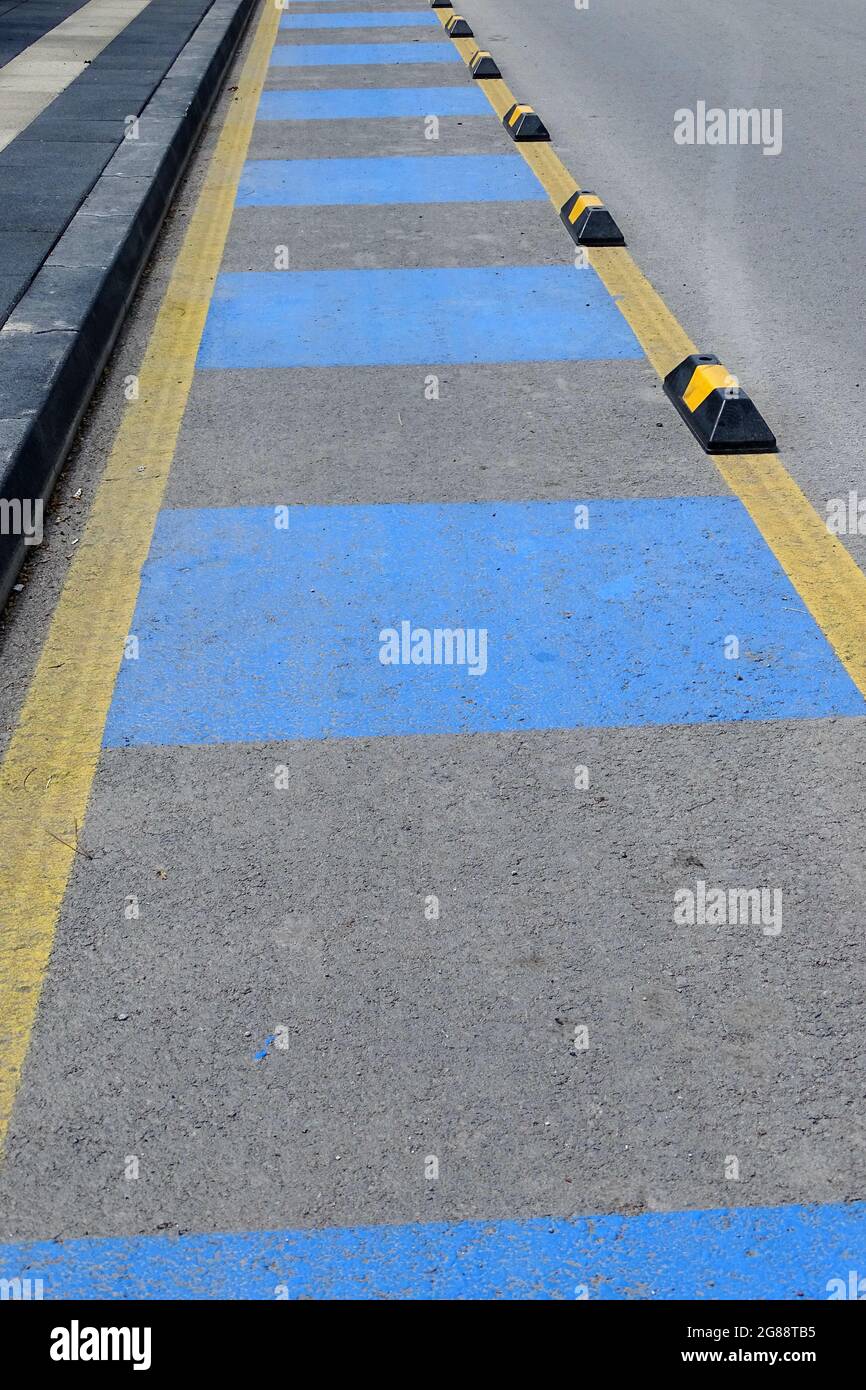 Blue road markings for pedestrian crossing Stock Photo - Alamy