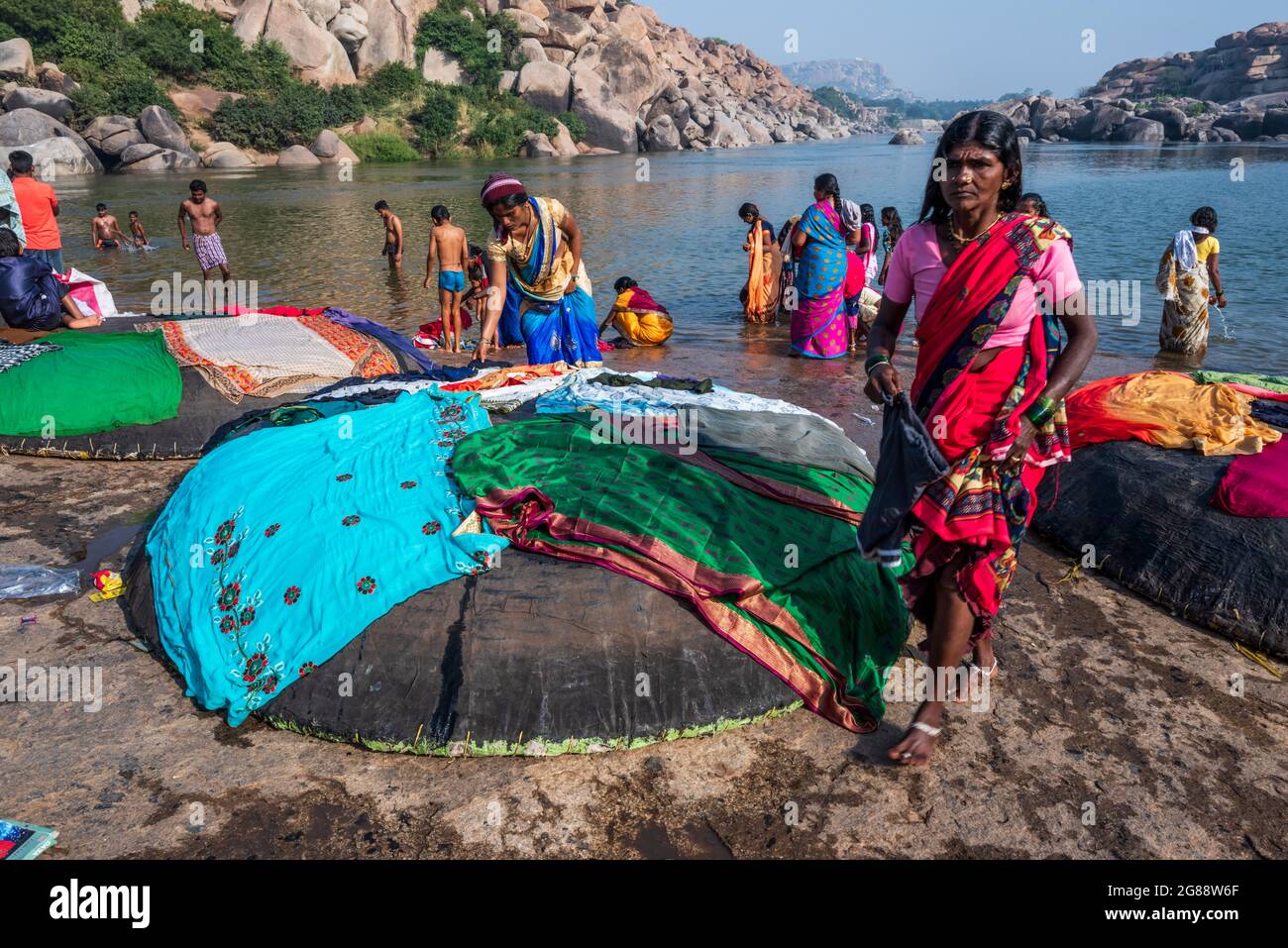 Hampi, Karnataka, India - January 10, 2020 : People bathing and getting ...