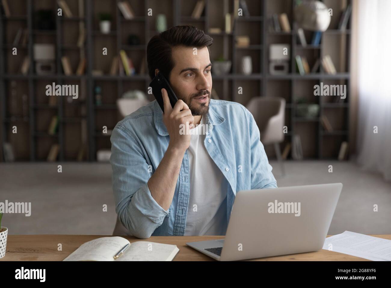 Thoughtful young man holding distant phone call conversation Stock ...