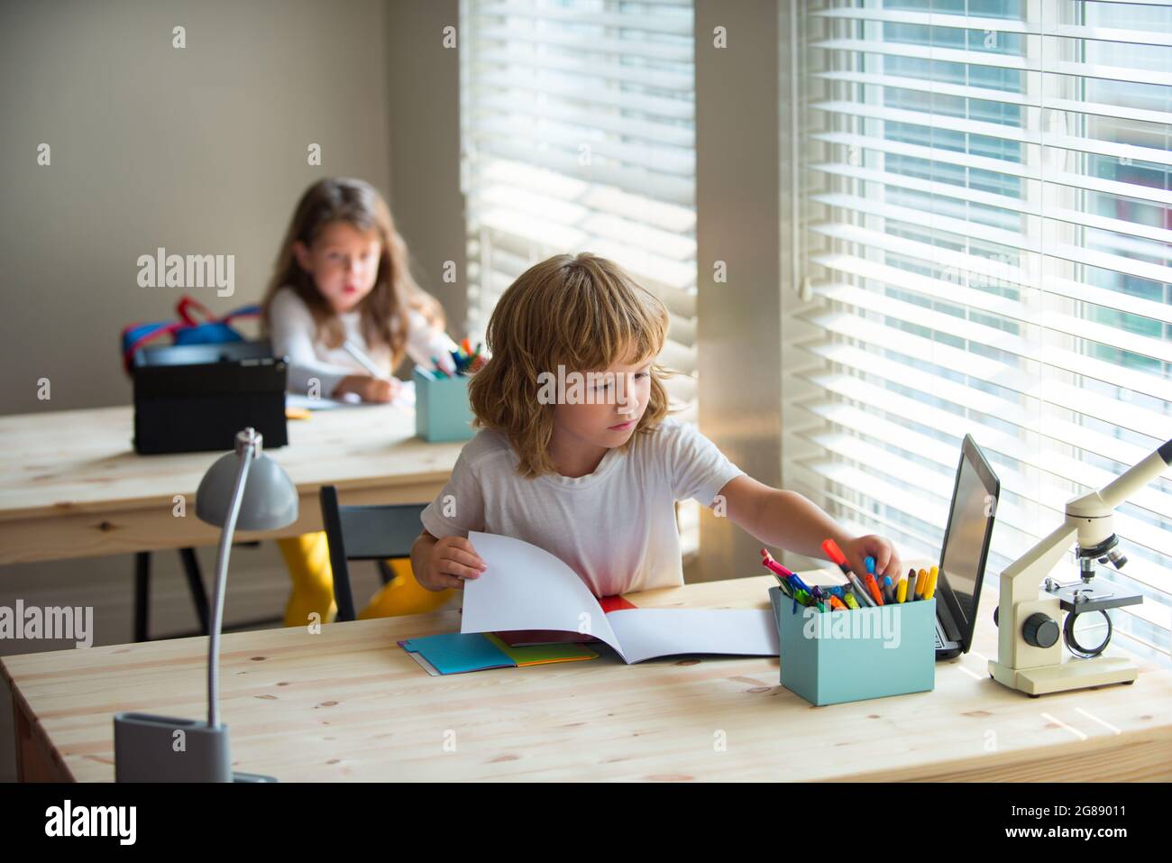 Kids at school. School boy with writing lesson Stock Photo - Alamy